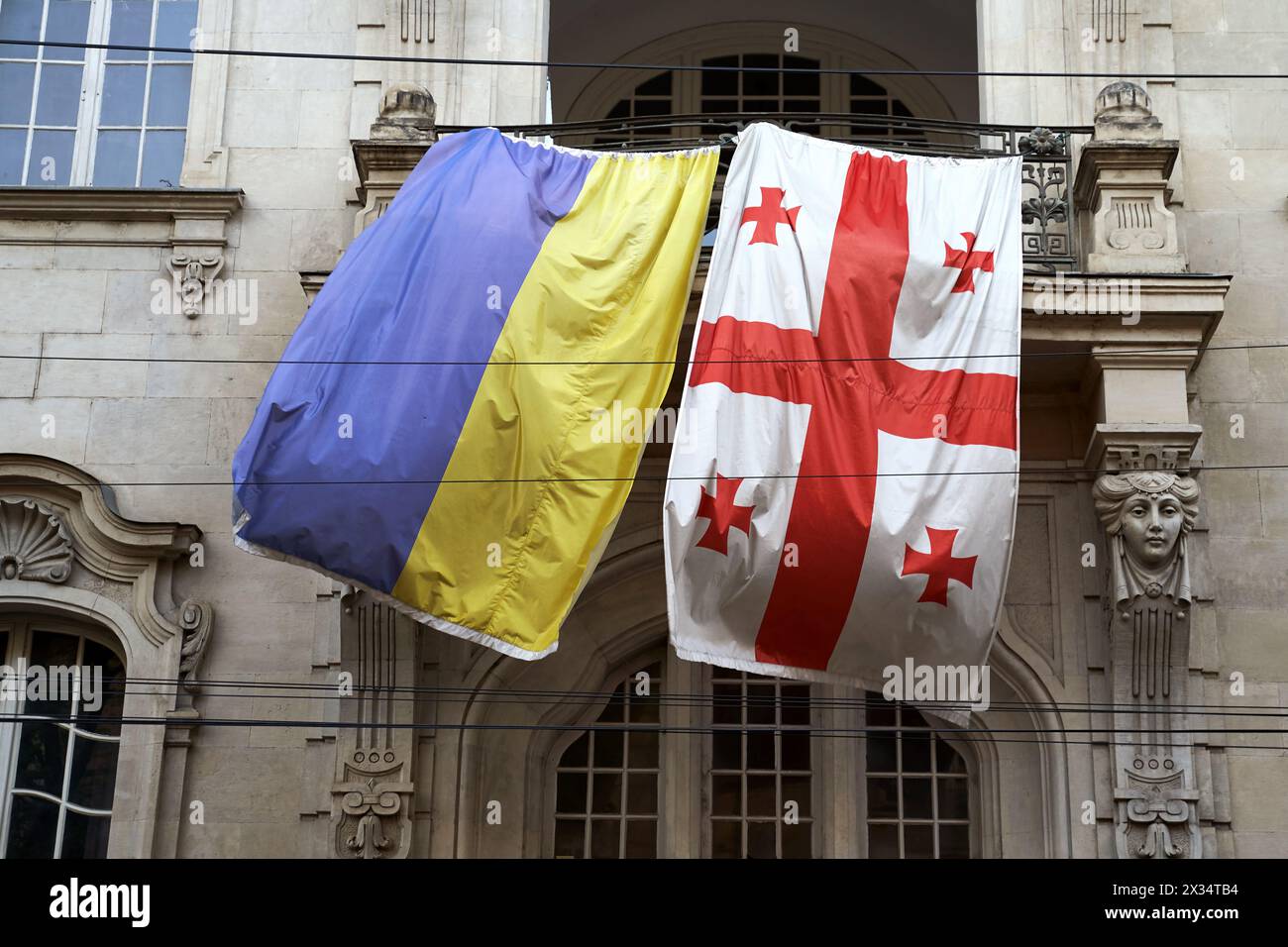 Flags of Ukraine and Georgia waving on the balcony of an old building ...