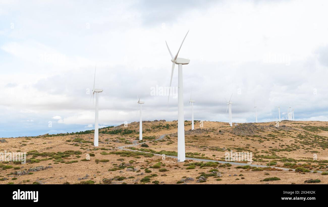 various mountain wind turbine with green grass and cloudy sky Stock ...
