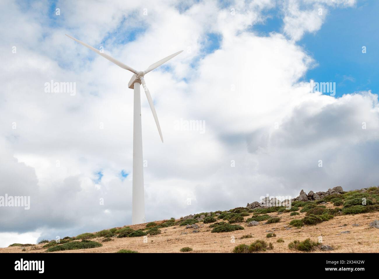 various mountain wind turbine with green grass and cloudy sky Stock ...