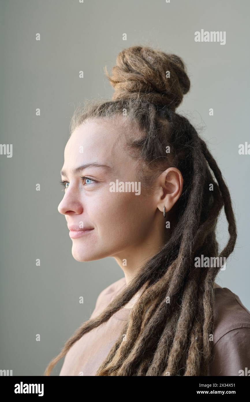 Vertical profile view portrait of Caucasian young woman with long ...