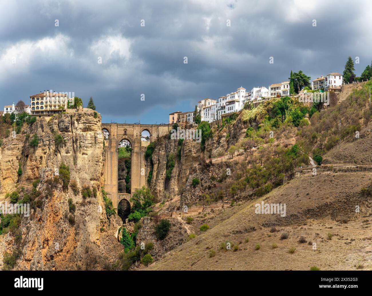 New bridge (Puente Nuevo) and the famous white houses on the cliffs in the city Ronda, Andalusia ...