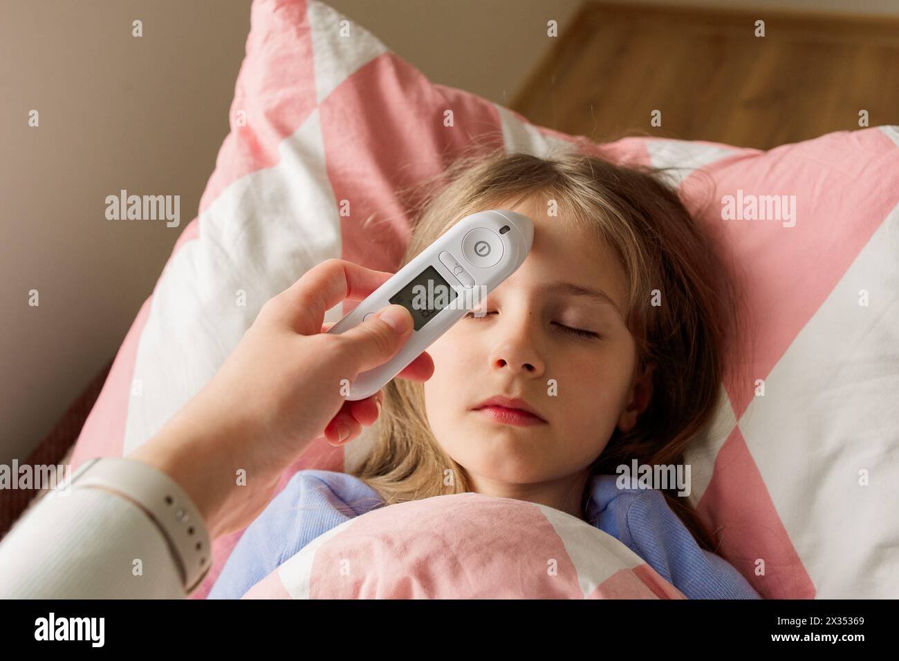 Sick daughter measuring fever hi-res stock photography and images - Alamy