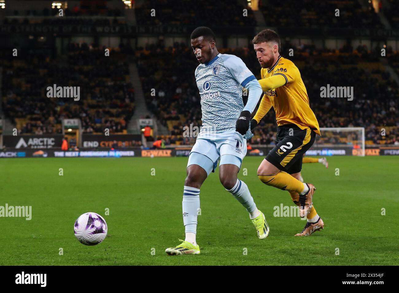 Dango Ouattara of Bournemouth holds off Matt Doherty of Wolverhampton ...