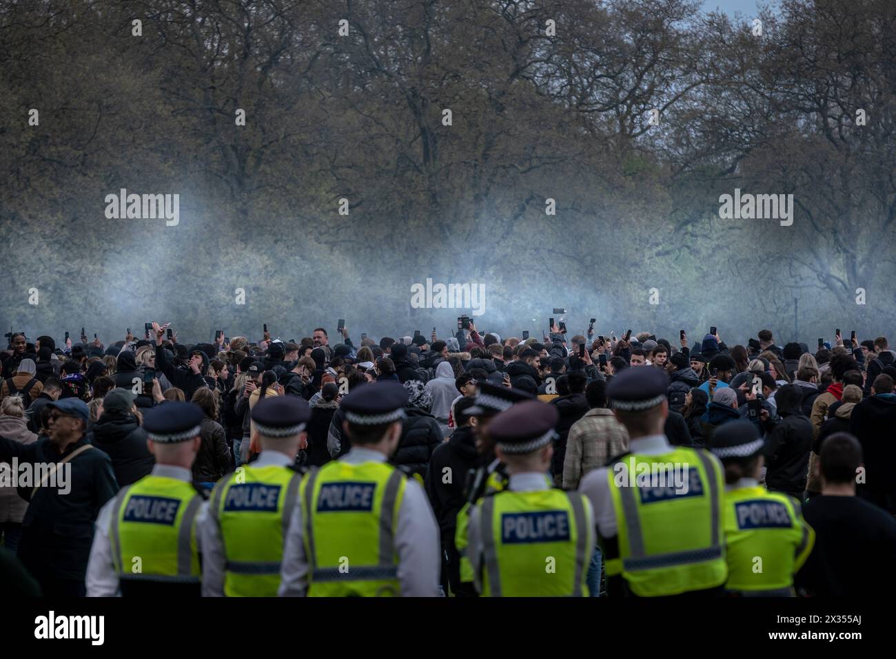 Police watch on as a massive smoke cloud rises as hundreds join the ...