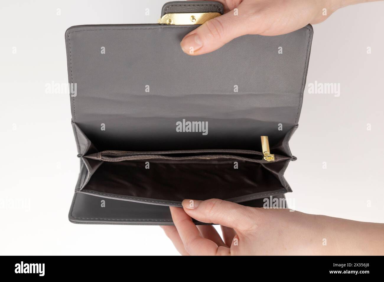 An empty purse in women's hands. The concept of poverty. A woman opens ...