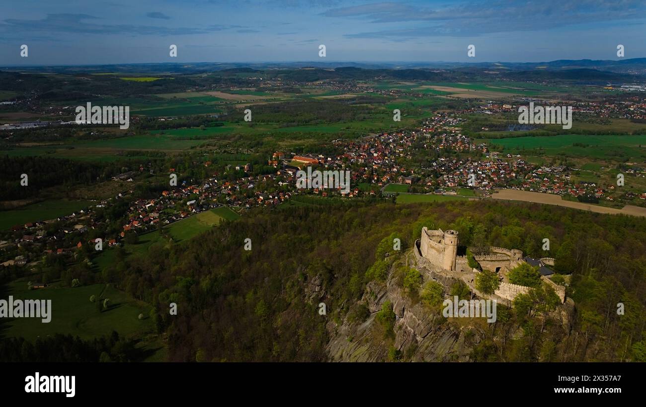 An aerial view captures the medieval Chojnik Castle atop a mountain in ...
