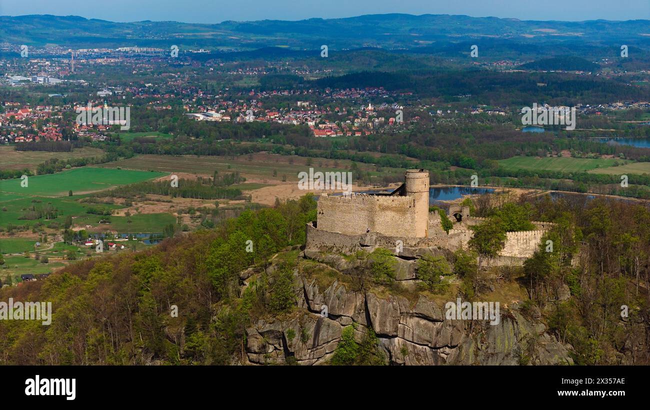 An aerial view captures the medieval Chojnik Castle atop a mountain in ...