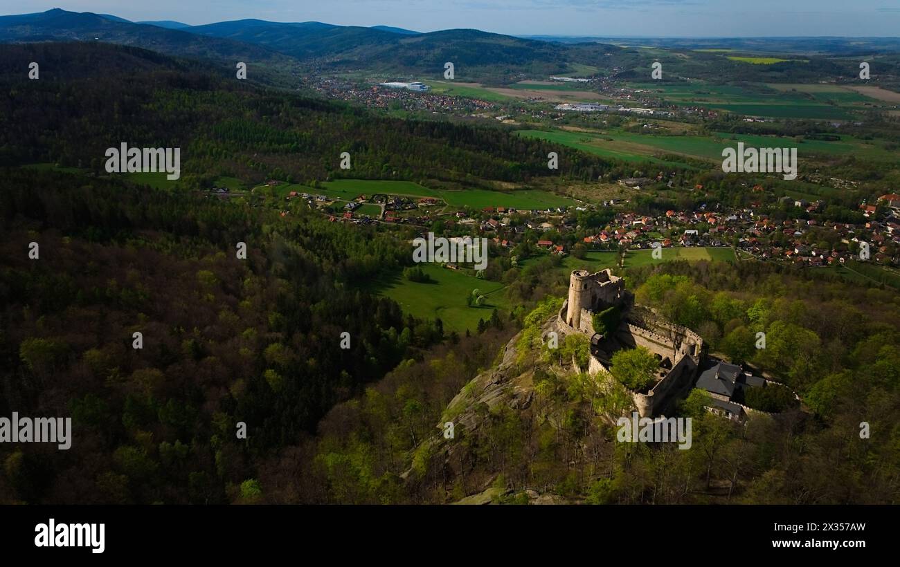 An aerial view captures the medieval Chojnik Castle atop a mountain in ...