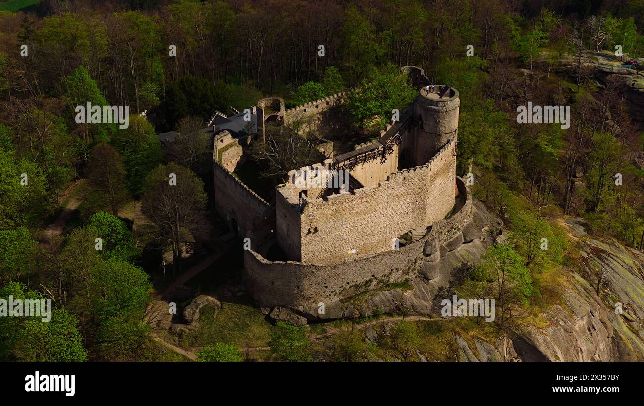An aerial view captures the medieval Chojnik Castle atop a mountain in ...