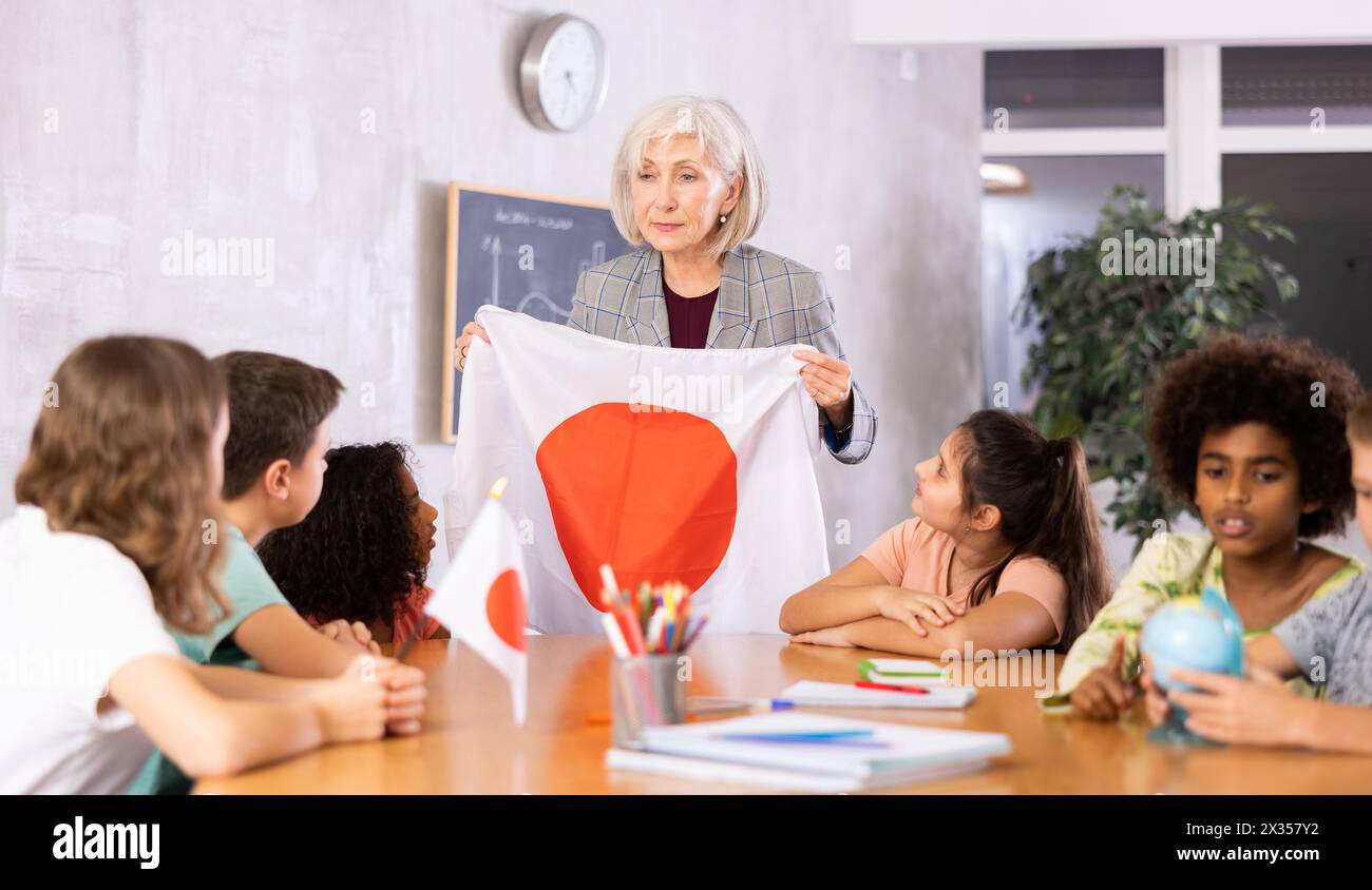 Friendly woman teacher tells pupils the history of Japan Stock Photo ...