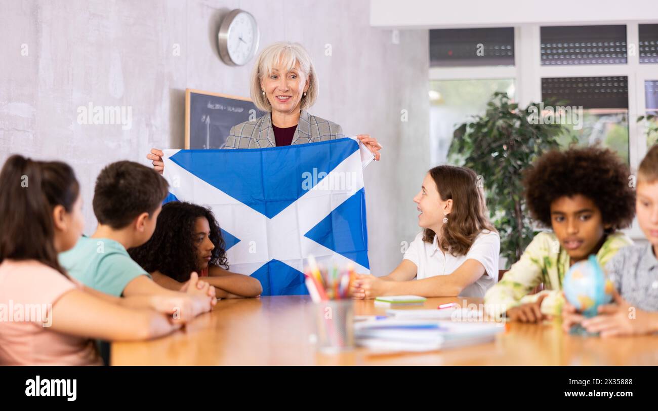 Friendly woman teacher tells pupils the history of Scotland Stock Photo ...