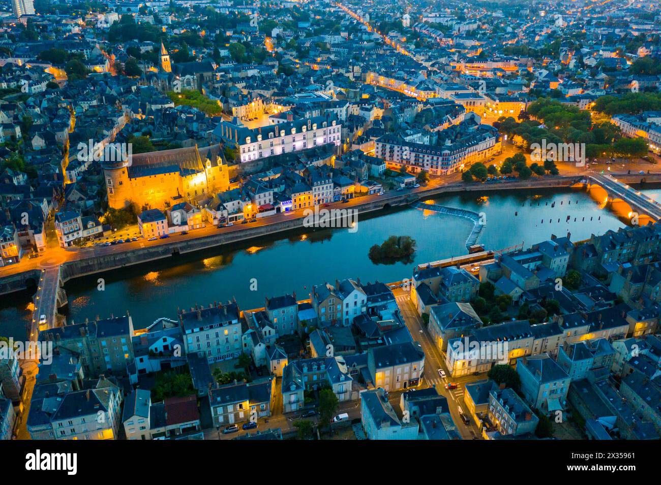 Evening aerial view of Laval with buildings, river Mayenne and old ...