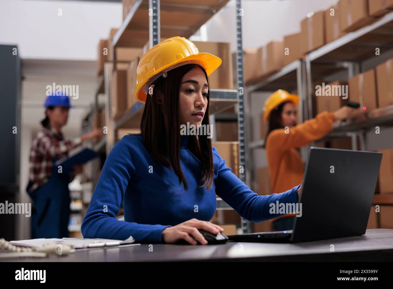 Asian retail storehouse employee analyzing orders checklist on laptop ...