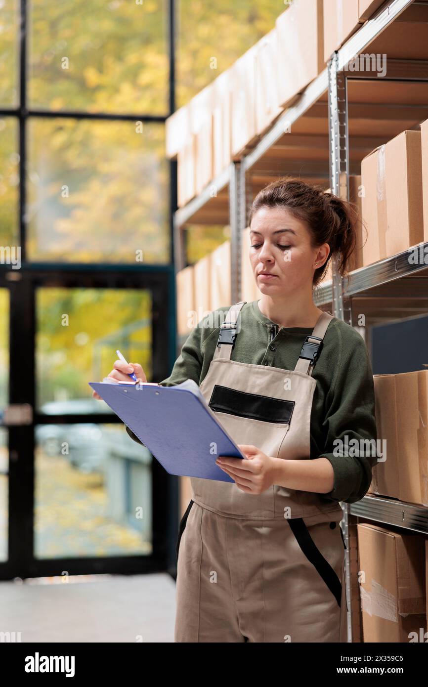Storehouse manager supervising cardboard boxes in mail sorting center ...