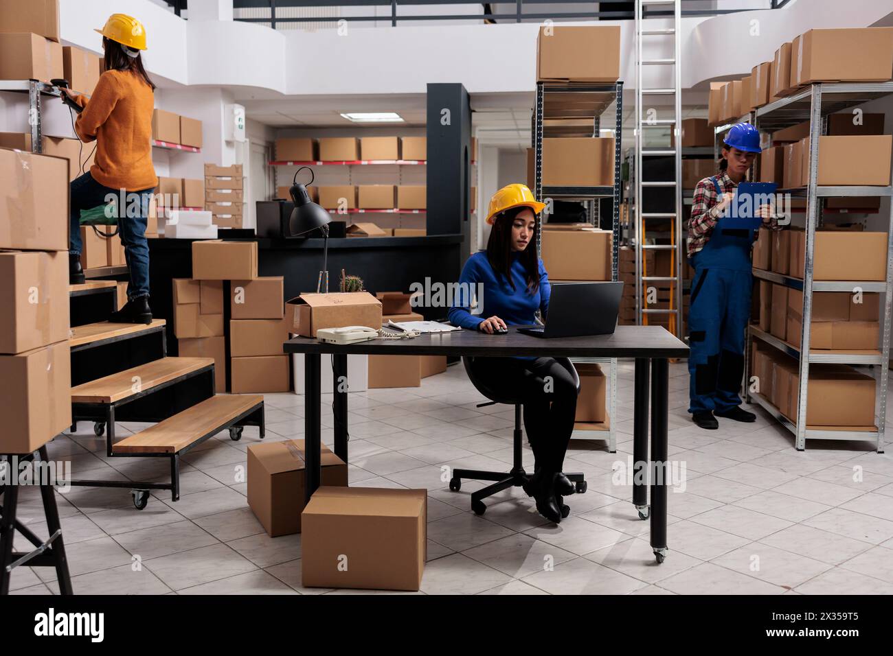 Asian delivery service employees team working in warehouse together ...