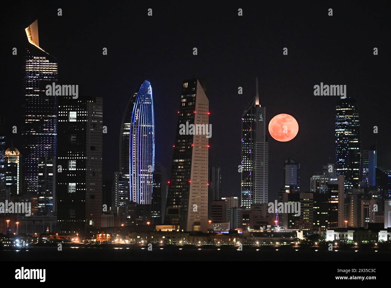 Kuwait City, Kuwait. 24th Apr, 2024. The moon rises behind the skyline ...