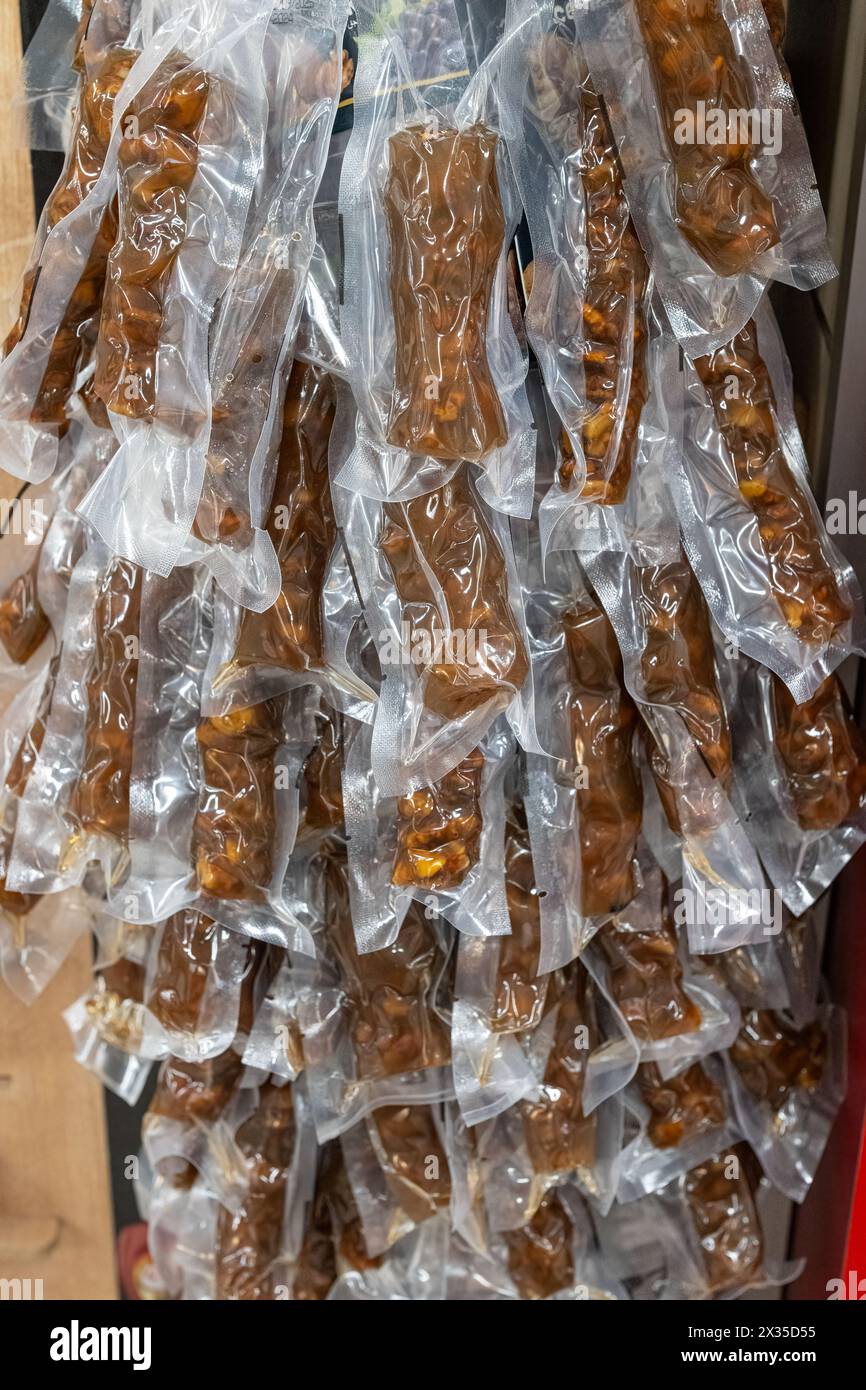 A sweet snack made of walnuts and molasses vacuum packed in plastic ...