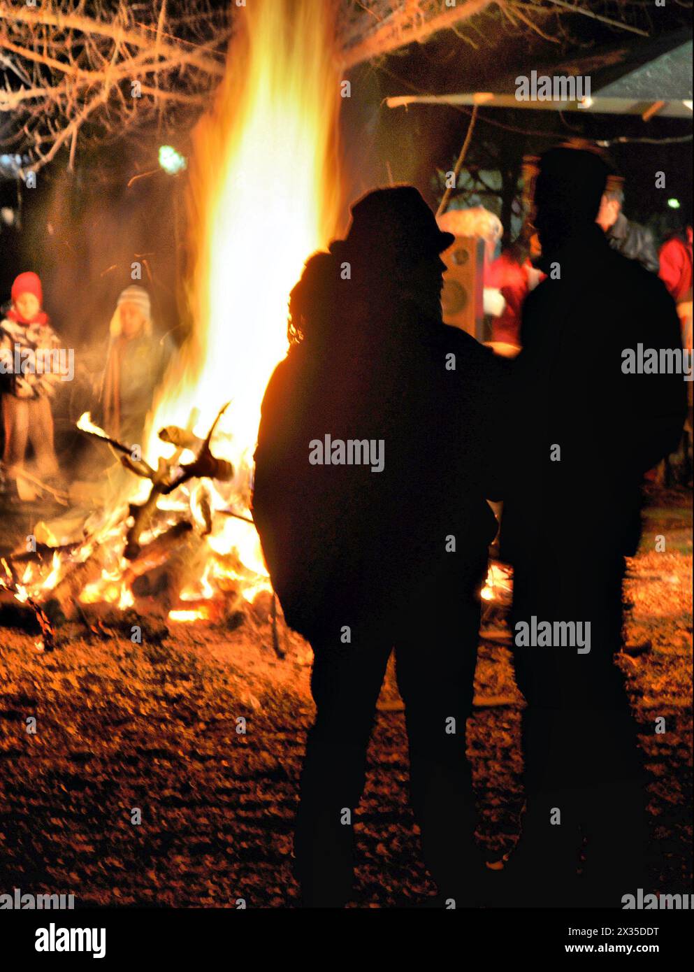 People gather around a fire during the Orthodox Christian holiday of ...