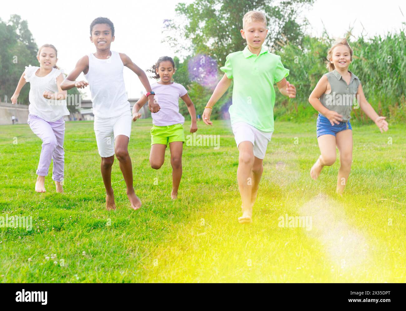 Barefoot kids running on green grass Stock Photo - Alamy