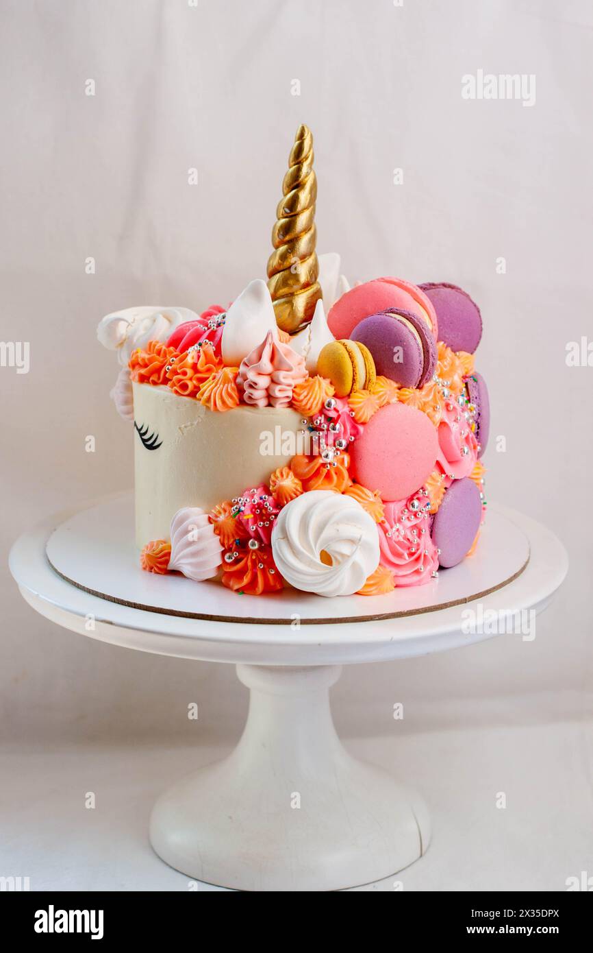 Unicorn cake with golden fondant horn, eyelashes and pink, orange ...