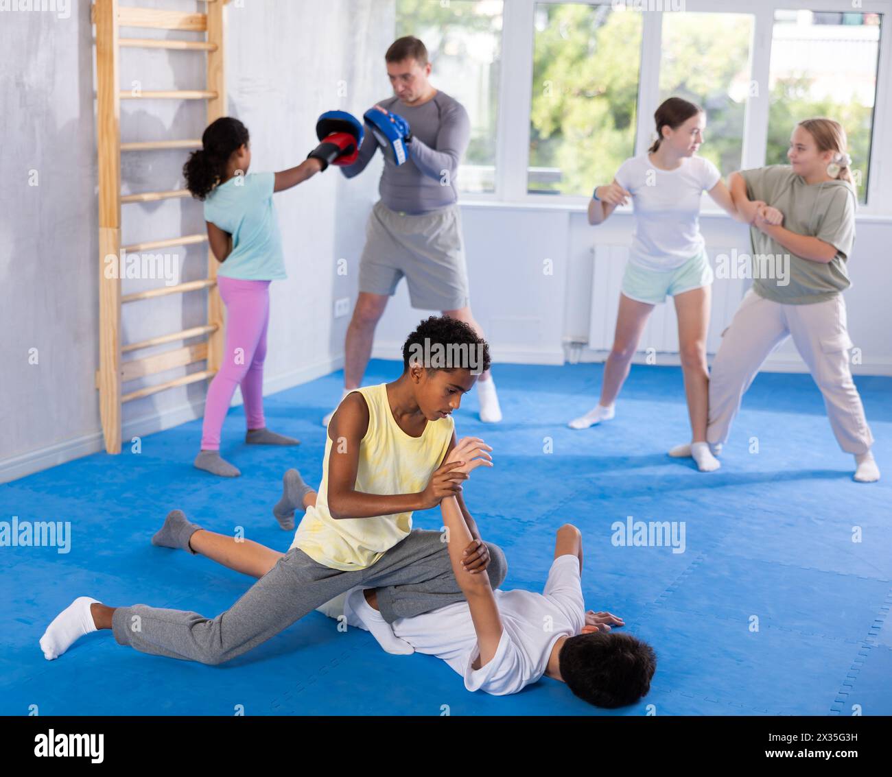 Two boys practicing self-defense techniques Stock Photo - Alamy