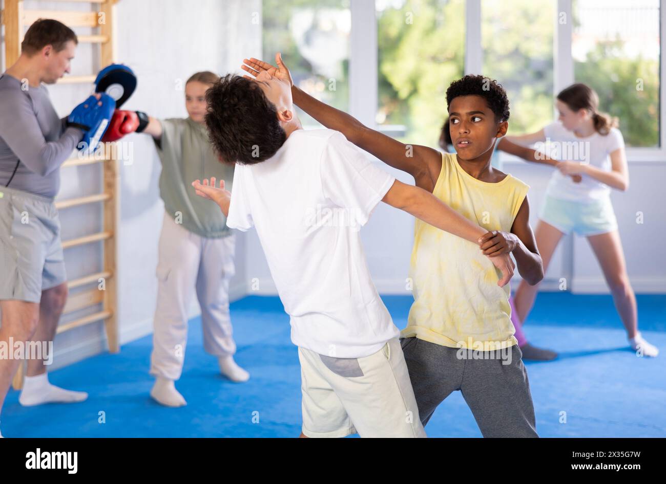 Two boys practicing self-defense techniques Stock Photo - Alamy