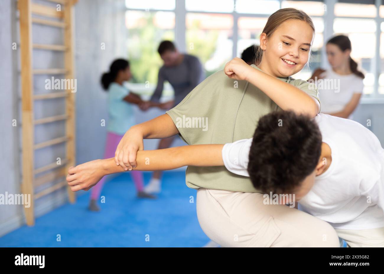 Boy and girl practicing self-defense techniques Stock Photo - Alamy