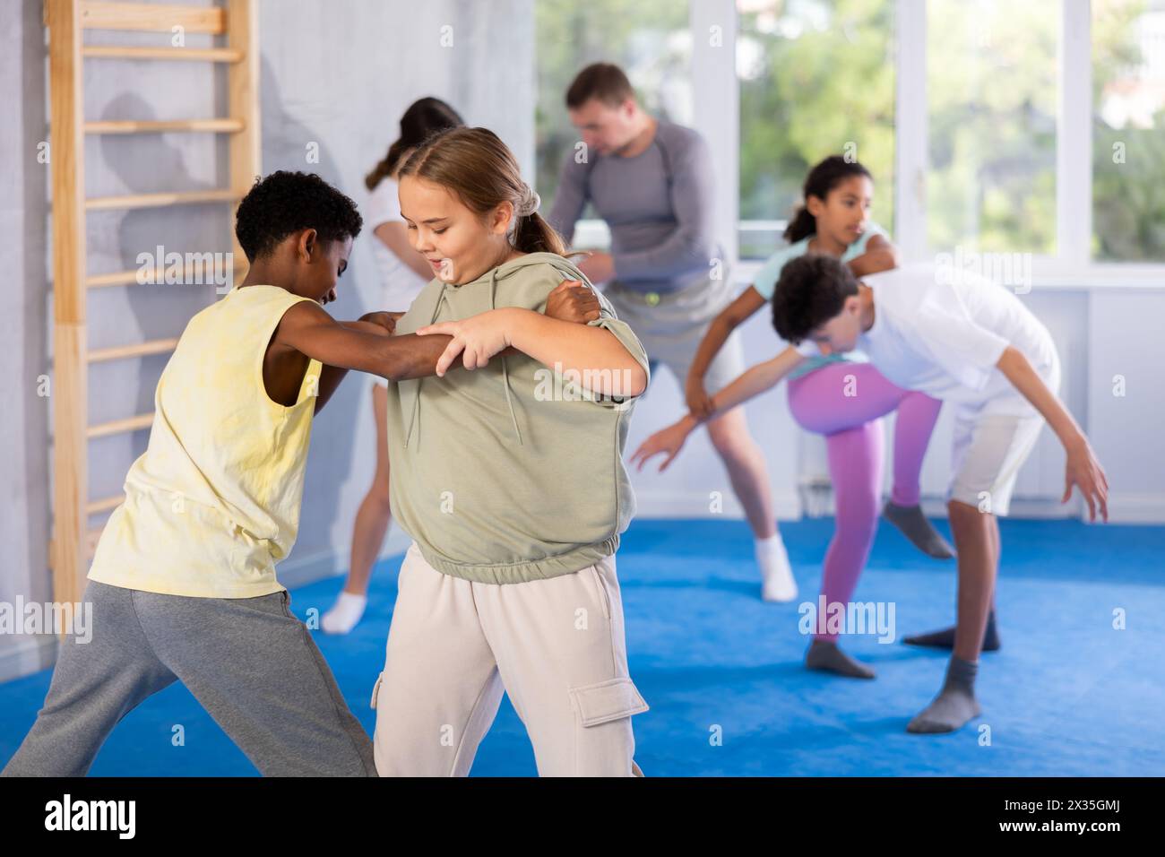 Boy and girl practicing self-defense techniques Stock Photo - Alamy