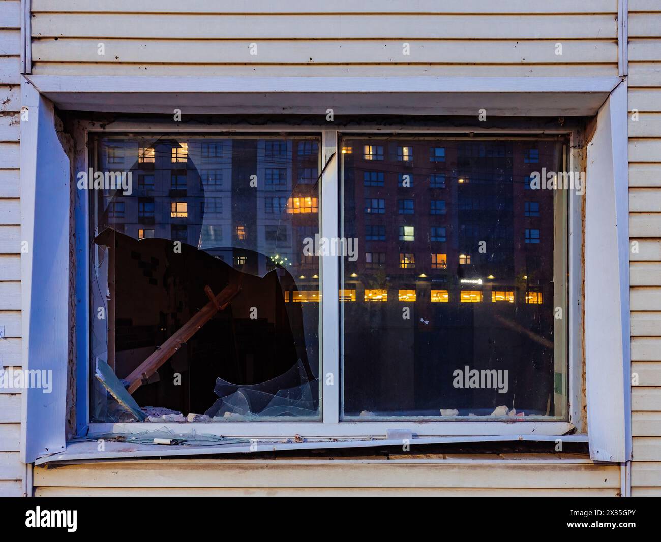 City reflecting in broken window Stock Photo - Alamy