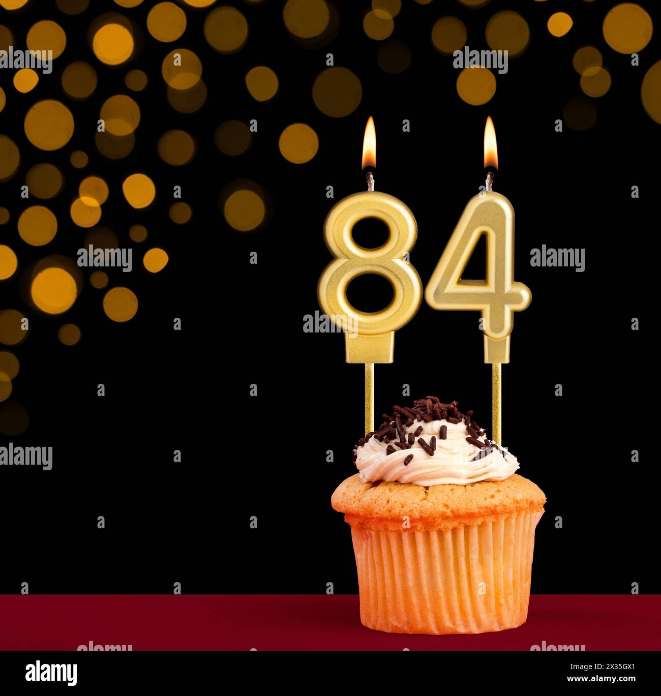 Birthday candle with cupcake - Number 84 on black background with out ...