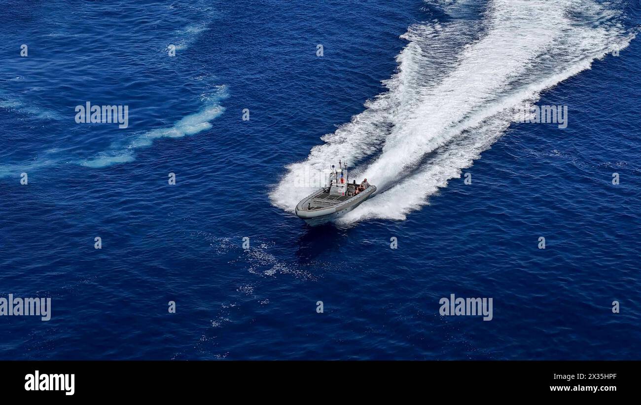 Sailors operate a 11-meter rigid-hulled inflatable boat (RHIB) during ...