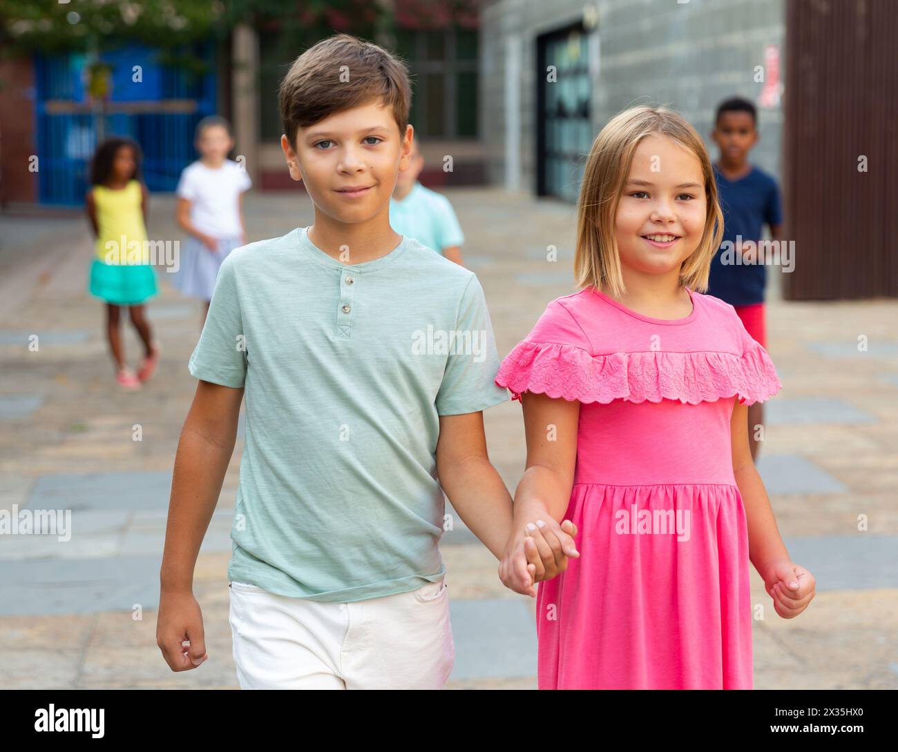 Happy tween girl and boy enjoying walk around city in summer Stock ...