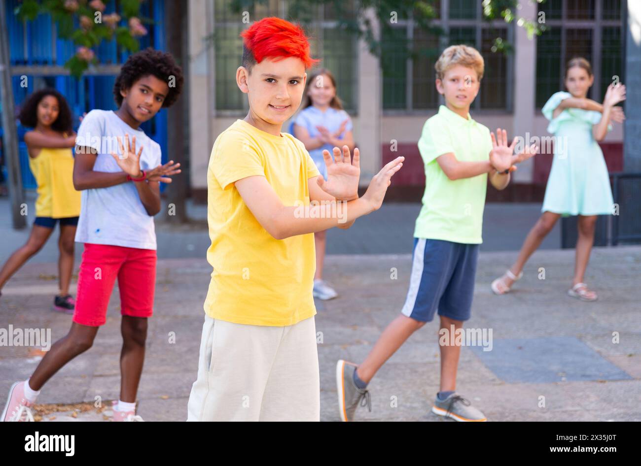 Tween boy dancing with group on summer city street Stock Photo - Alamy
