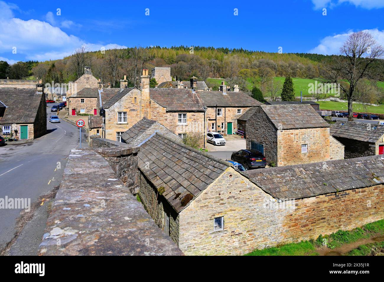The bridge and road into Blanchland village Northumberland on a lovely ...
