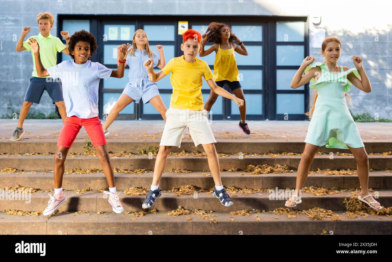 Group of kids performing street dance outdoors Stock Photo - Alamy
