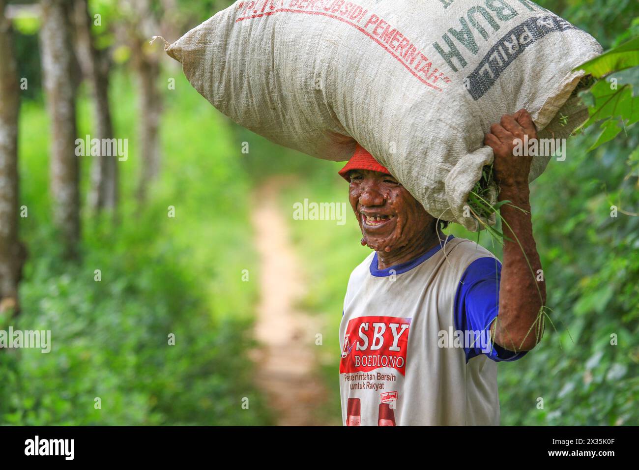 Indian man carrying sack hi-res stock photography and images - Alamy
