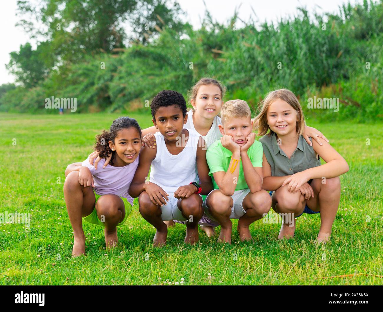 Group photo of kids on grass Stock Photo - Alamy