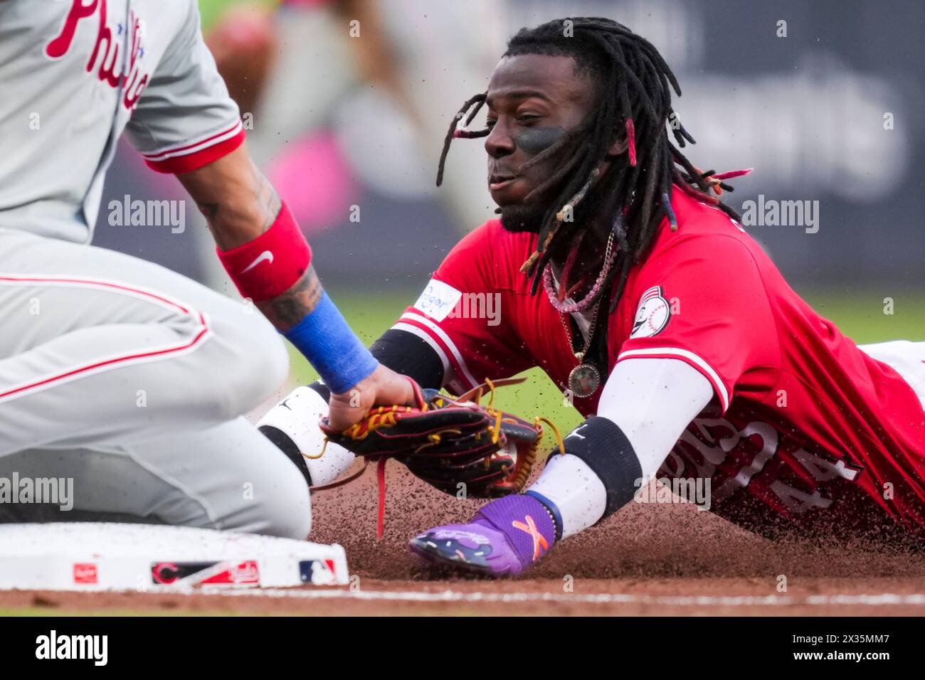 Cincinnati Reds' Elly De La Cruz, right, slides into third base on an ...