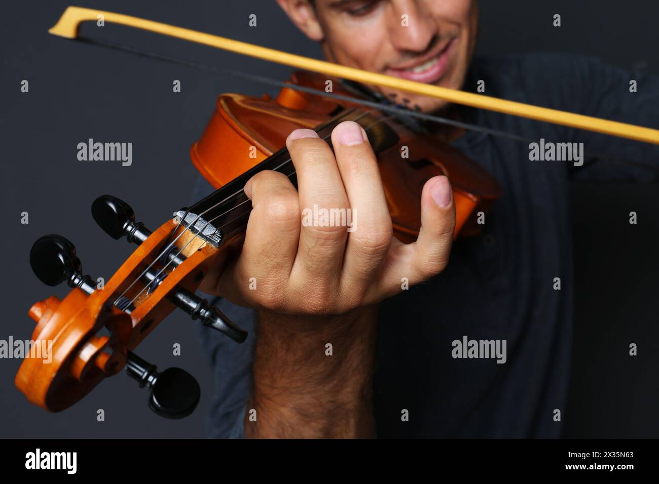 Man playing violin on black background, closeup Stock Photo - Alamy