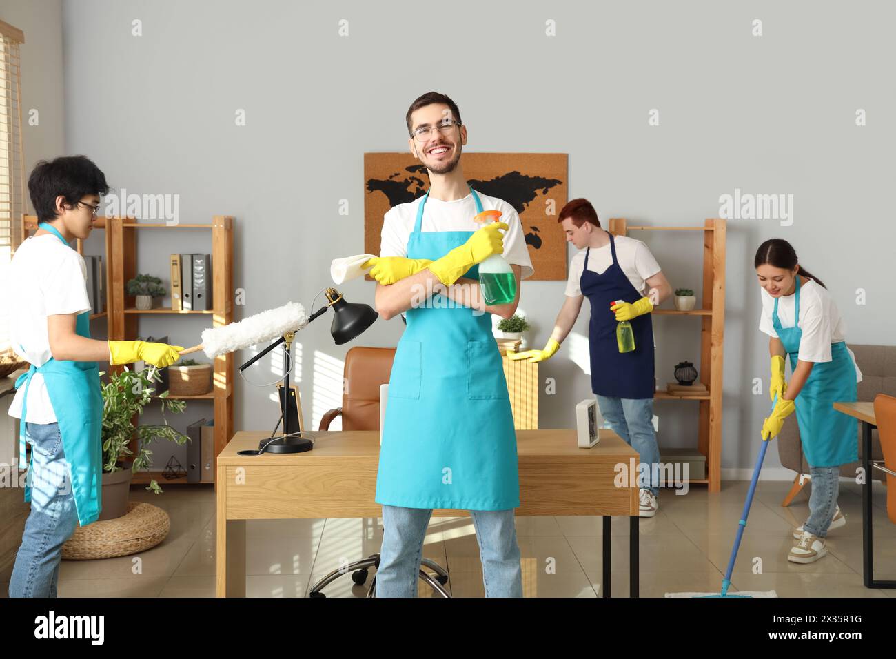 Male janitor with detergent and rag in office Stock Photo - Alamy