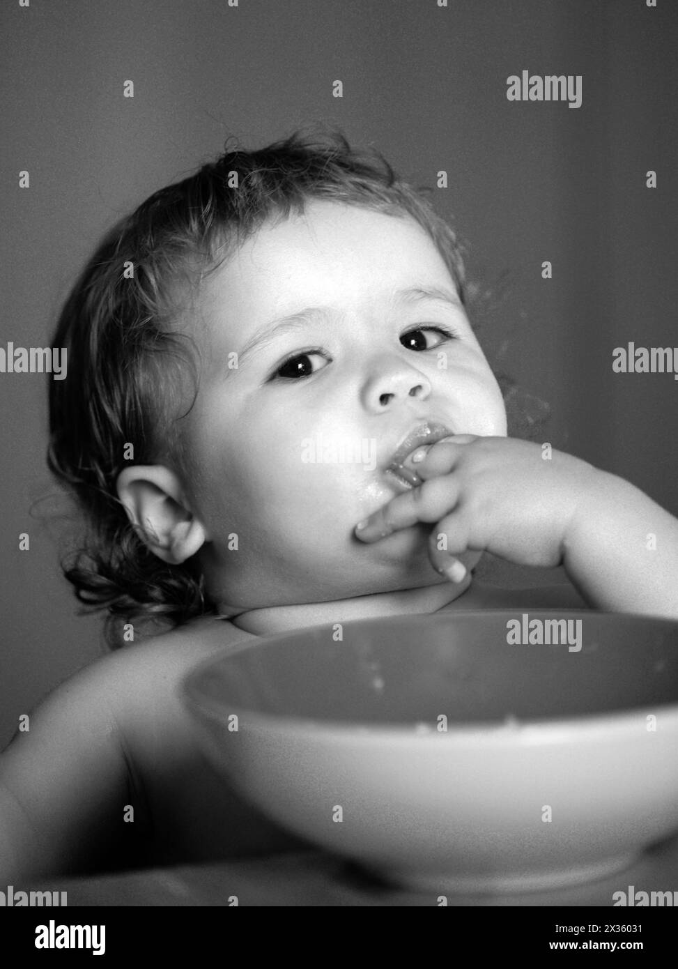 Portrait of cute Caucasian child kid with spoon. Hungry messy baby with ...