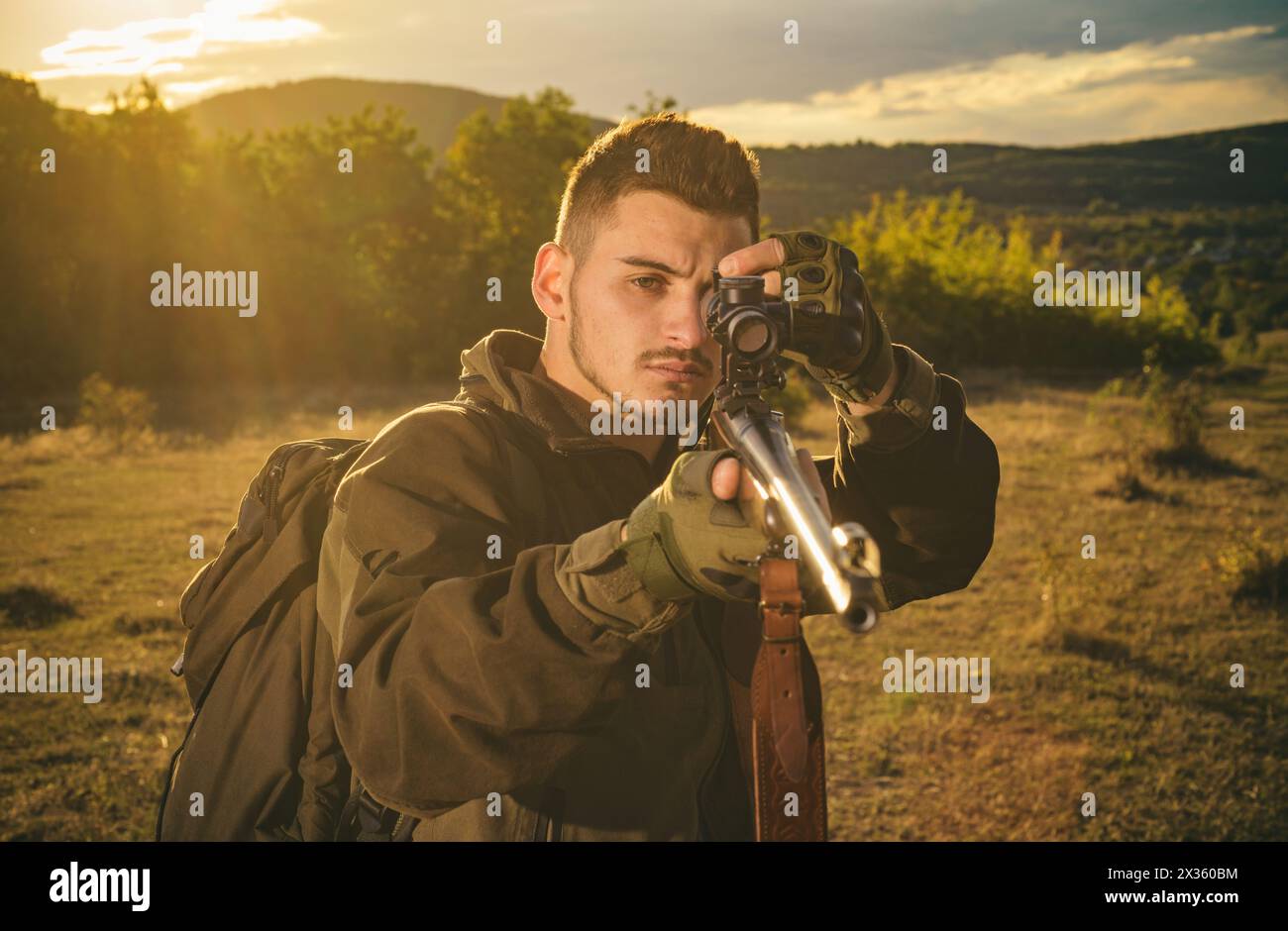 Hunter with Powerful Rifle with Scope Spotting Animals. Hunter Classic ...
