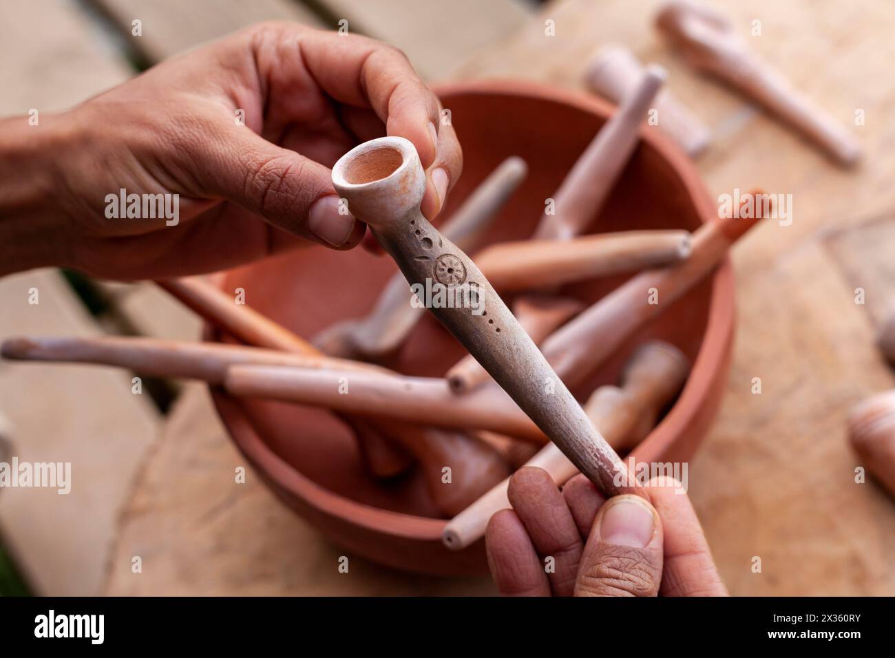 Hand holding a handcrafted clay pipe Stock Photo - Alamy