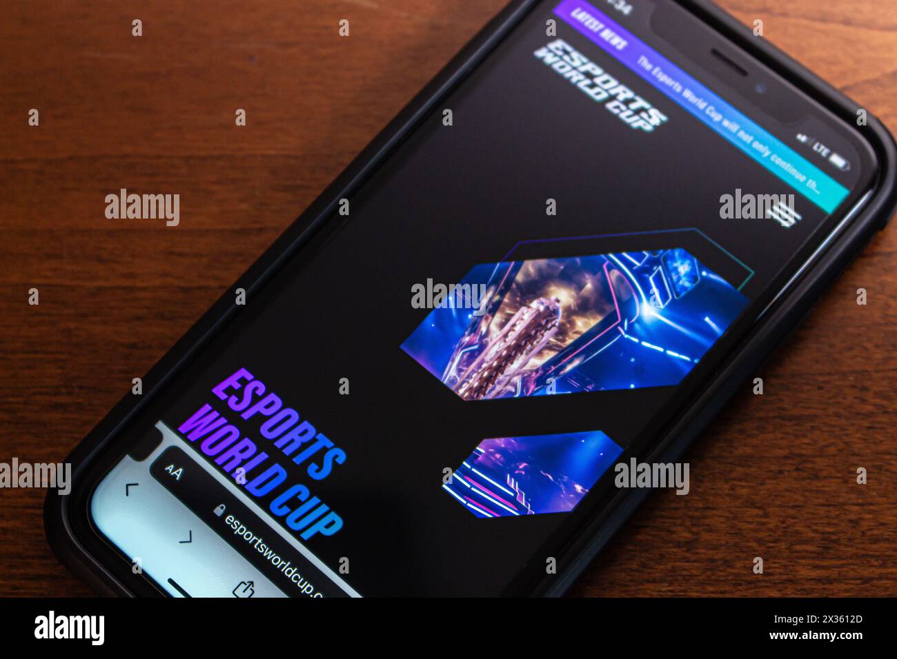 Website of 2024 Esports World Cup seen in an iPhone screen. EWC is an ...