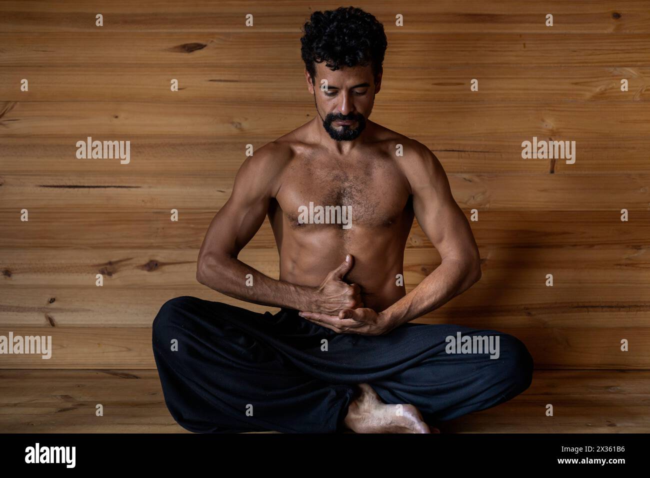 Latin American male yogi seated in the Limgan Mudra position. Concept ...