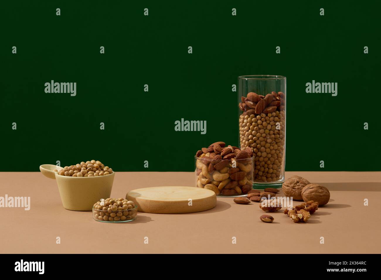 Various types of nuts are displayed over the dark background with a ...