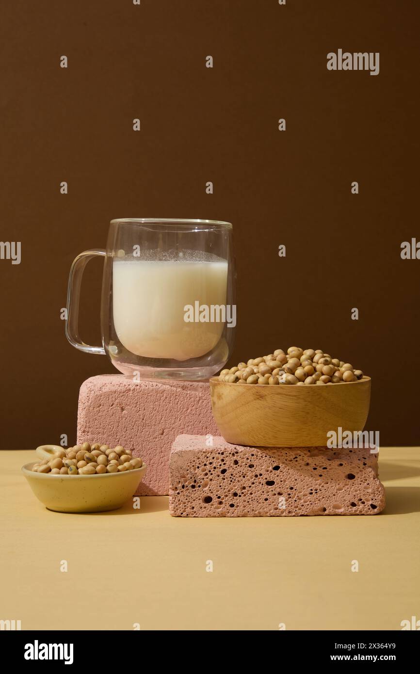 A mug of soya milk decorated with two bowls containing soybeans on the ...