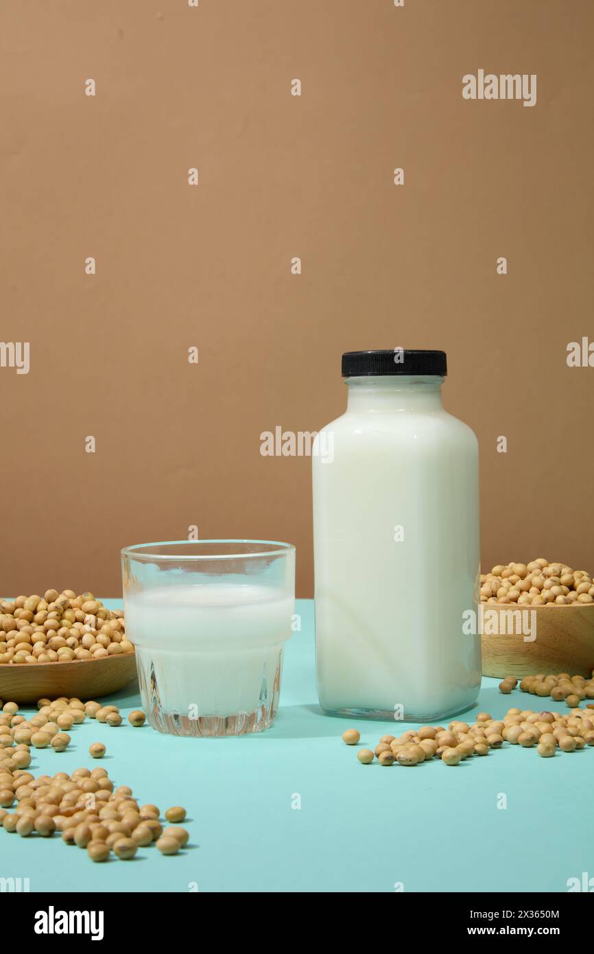 Soya milk filled inside a cup and unbranded bottle, displayed with a ...