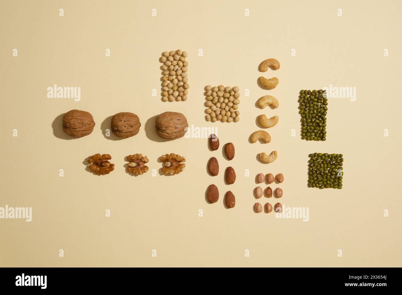 View from above of different types of beans and nuts against the beige ...