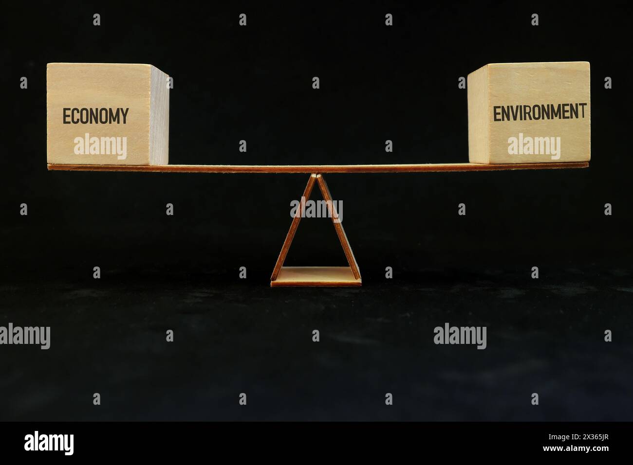 Economy versus environment concept. Human hand picking up wooden block ...